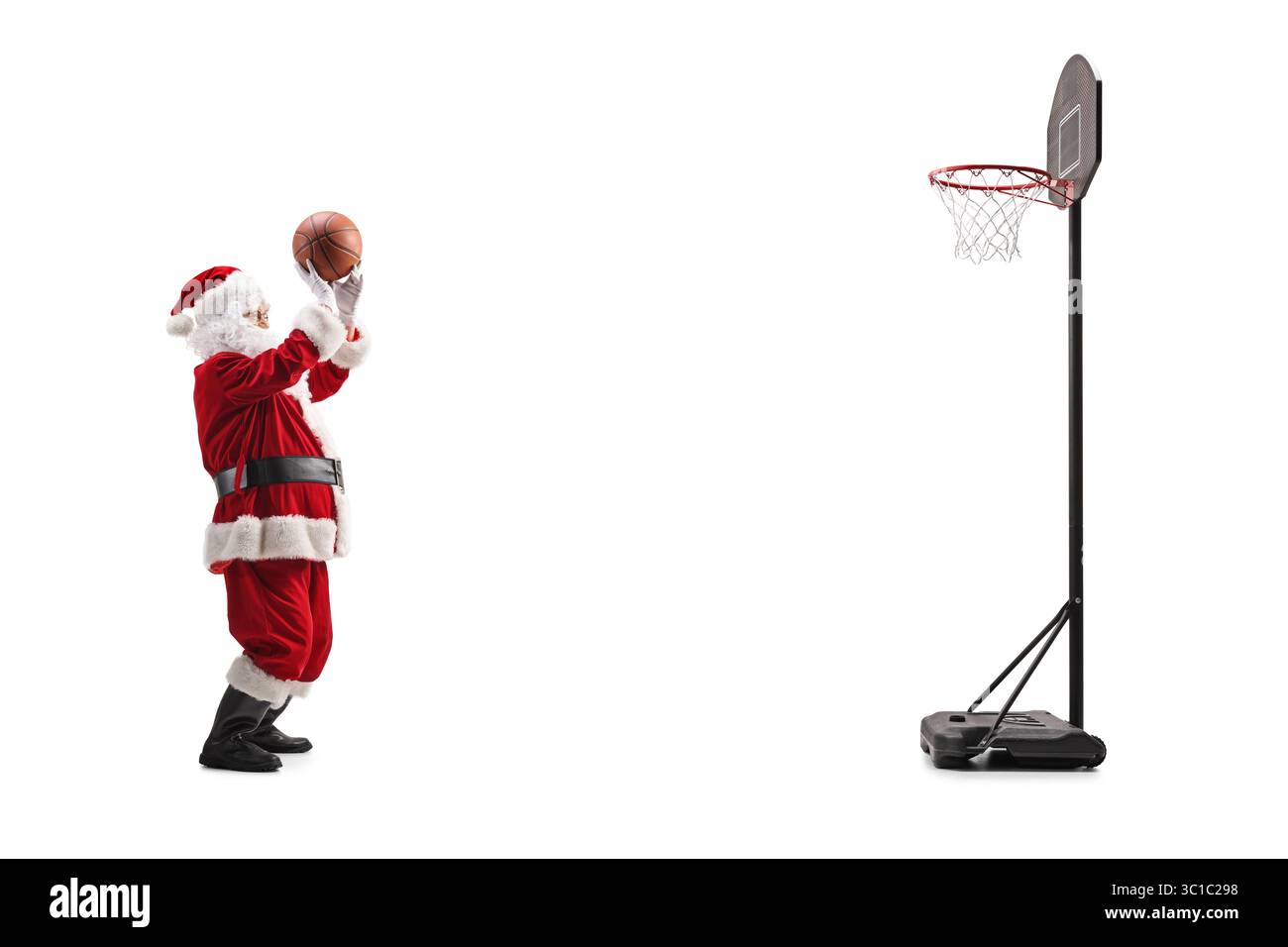 Santa claus shooting a basketball isolated on white background Stock ...