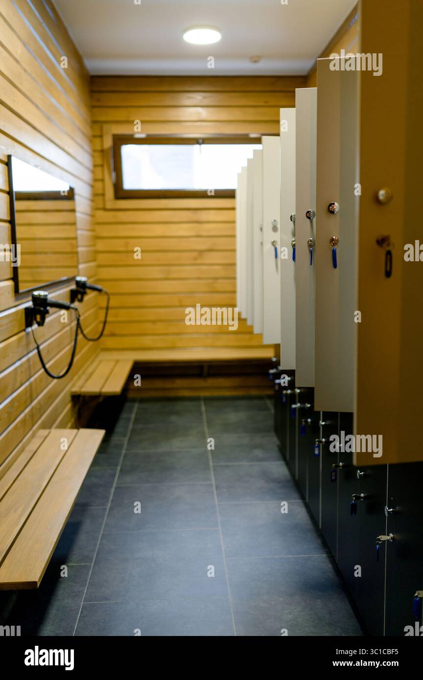 Modern changing room interior with wood trim and lockers. Changing room ...