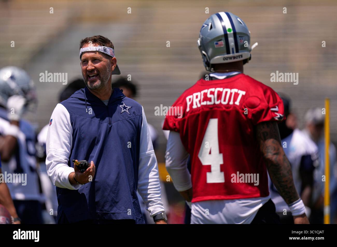 Dallas Cowboys head coach Brian Schottenheimer talks with quarterback ...