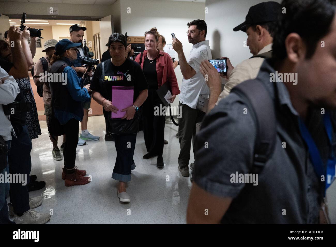 New York, United States. 22nd July, 2025. A woman leaves their hearing ...