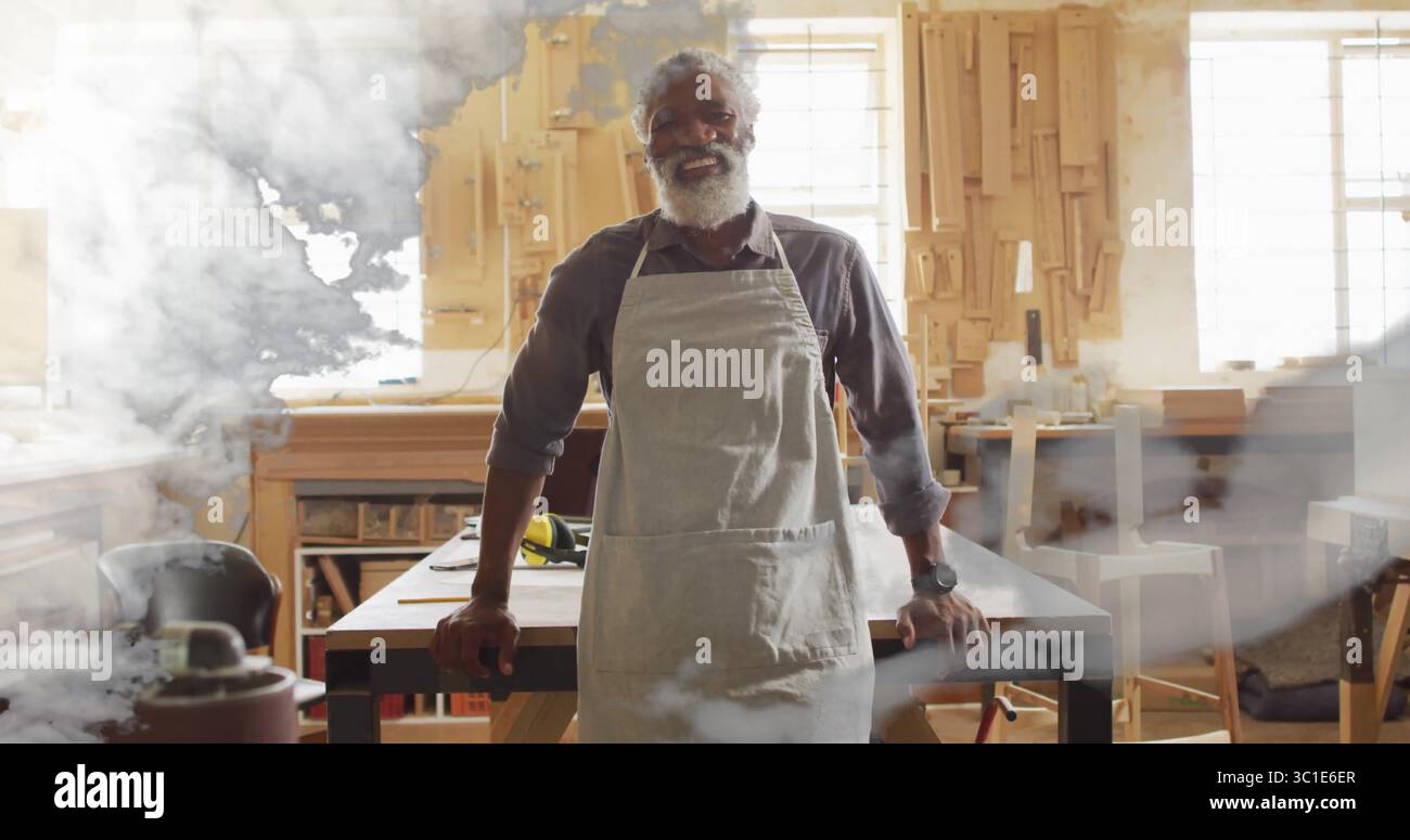 Standing African American carpenter wearing gray apron sanding wooden ...