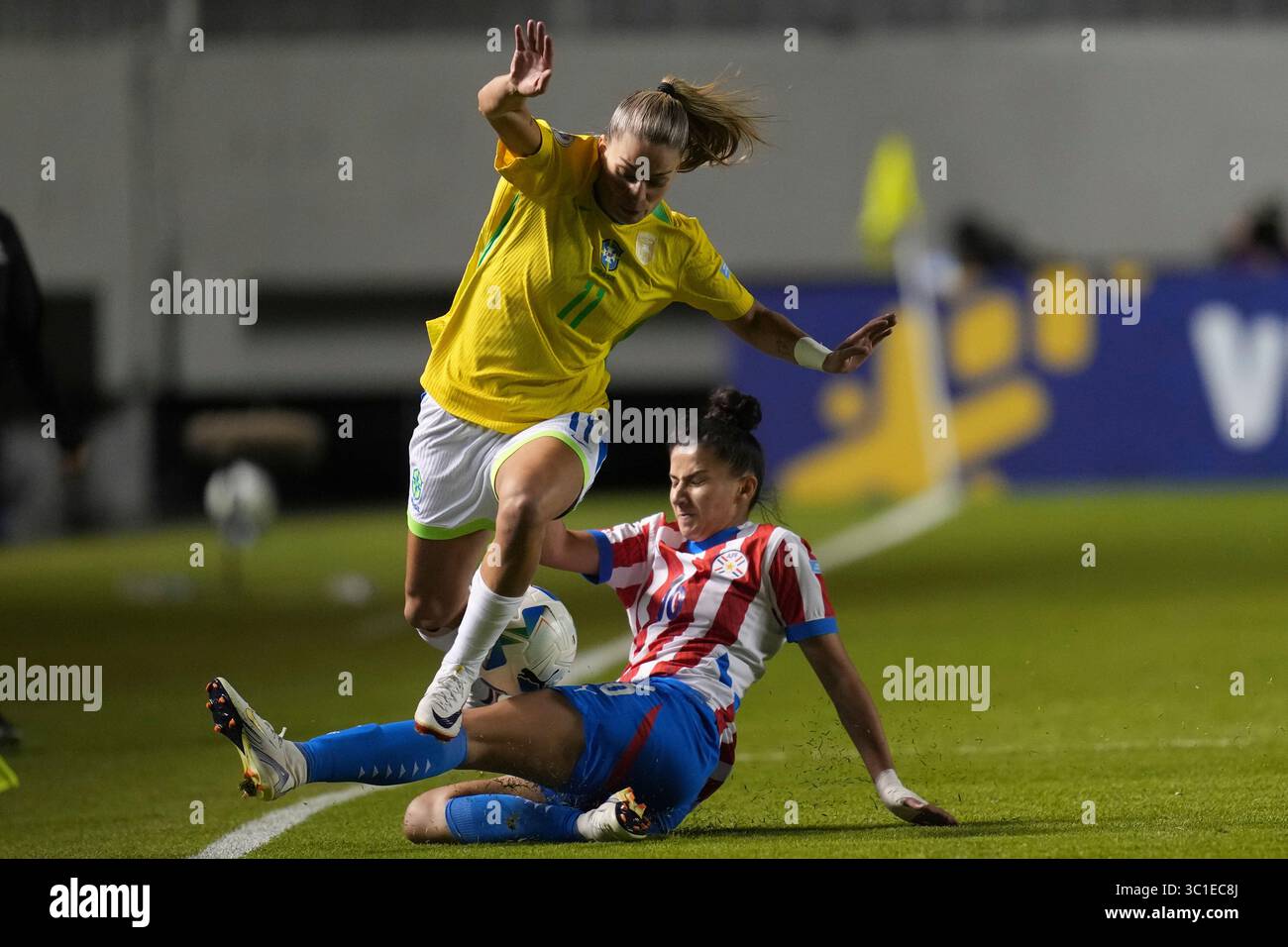 Gio of Brazil jumps over Fiorela Martinez of Paraguay during a Women's ...