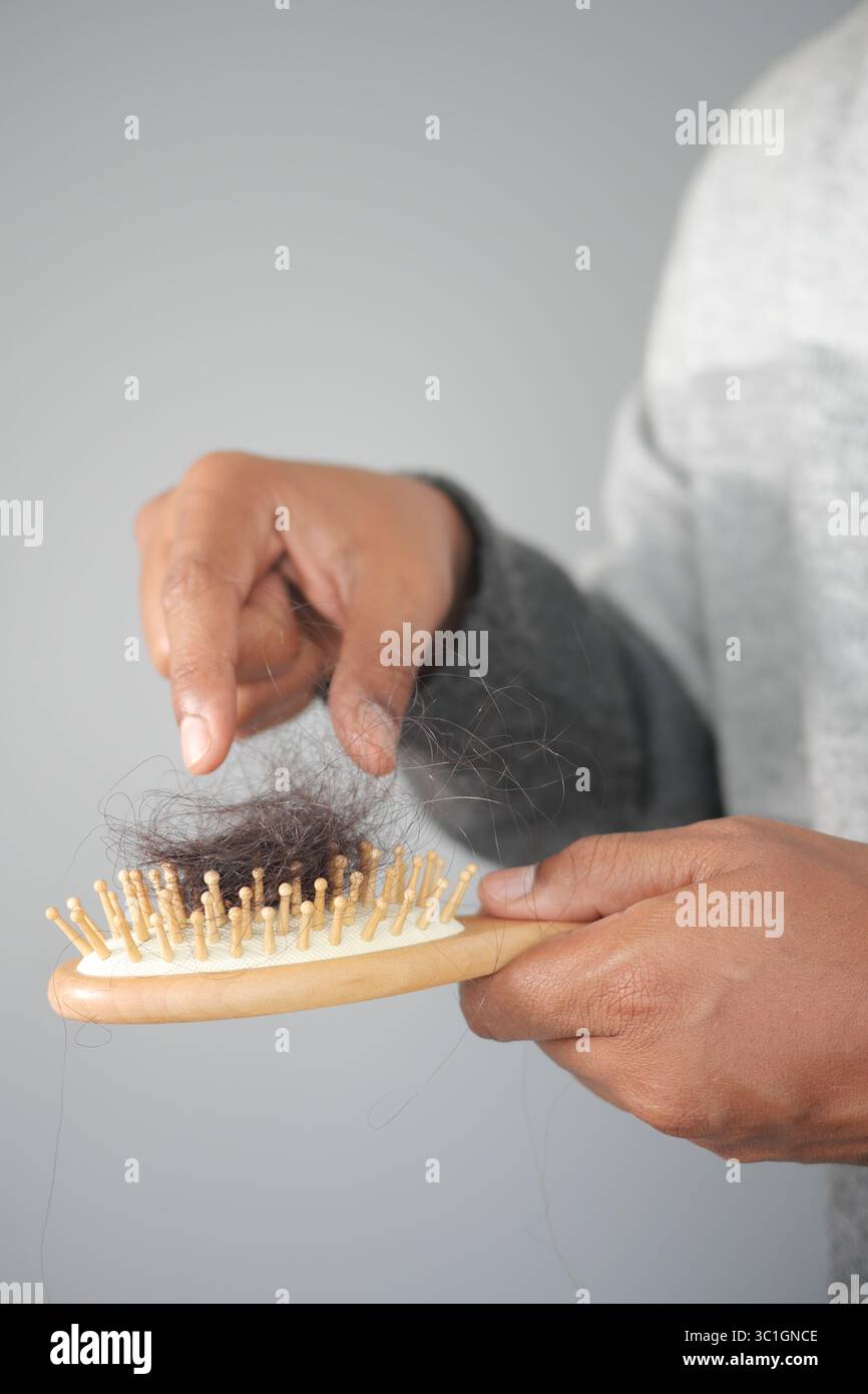 Hands removing hair from brush hi-res stock photography and images - Alamy