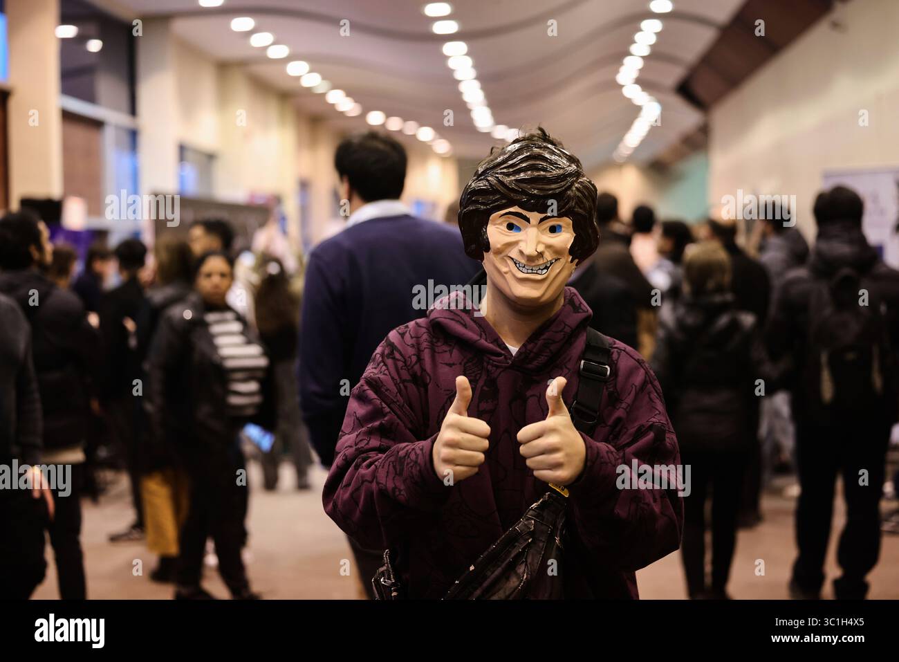 A person wearing a mask of Argentina's President Javier Milei poses for ...