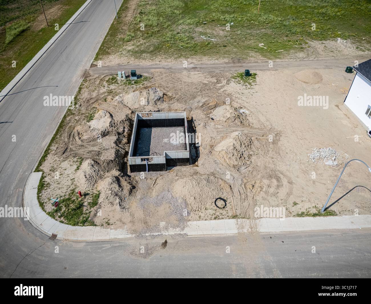 Construction site with a dirt area and a cement slab. The dirt area is ...