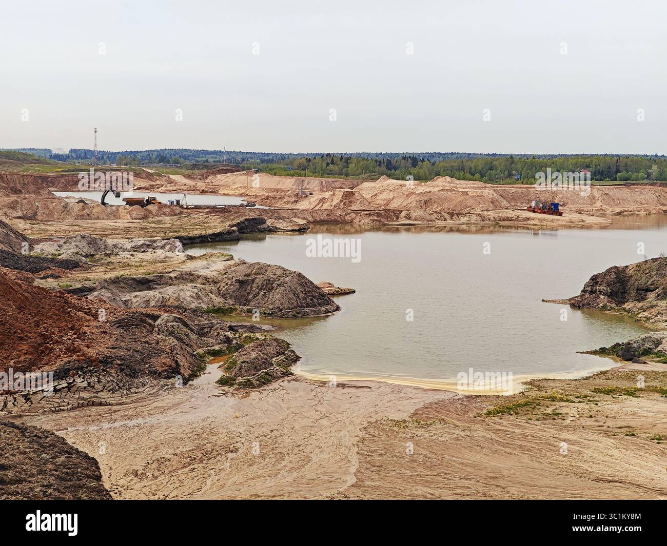 Yellow-orange toxic waste in water in sandpit. Ecology concept Stock ...