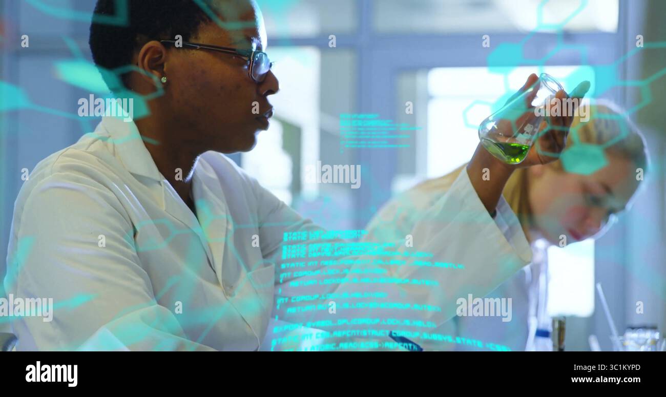 Inspecting scientist wearing lab coat holding conical flask in lab ...