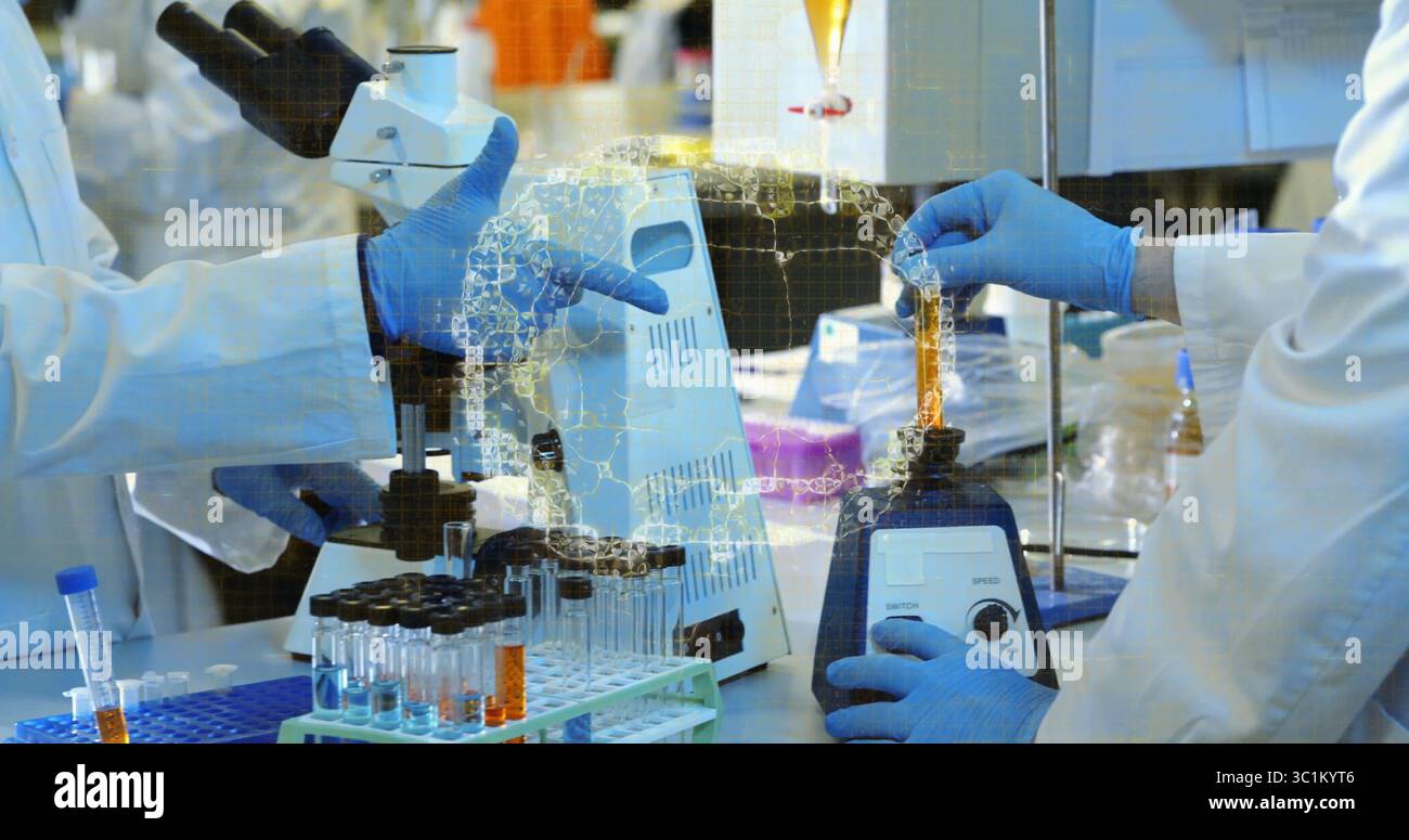 Scientist in white coat dispensing amber solution into test tube at lab ...