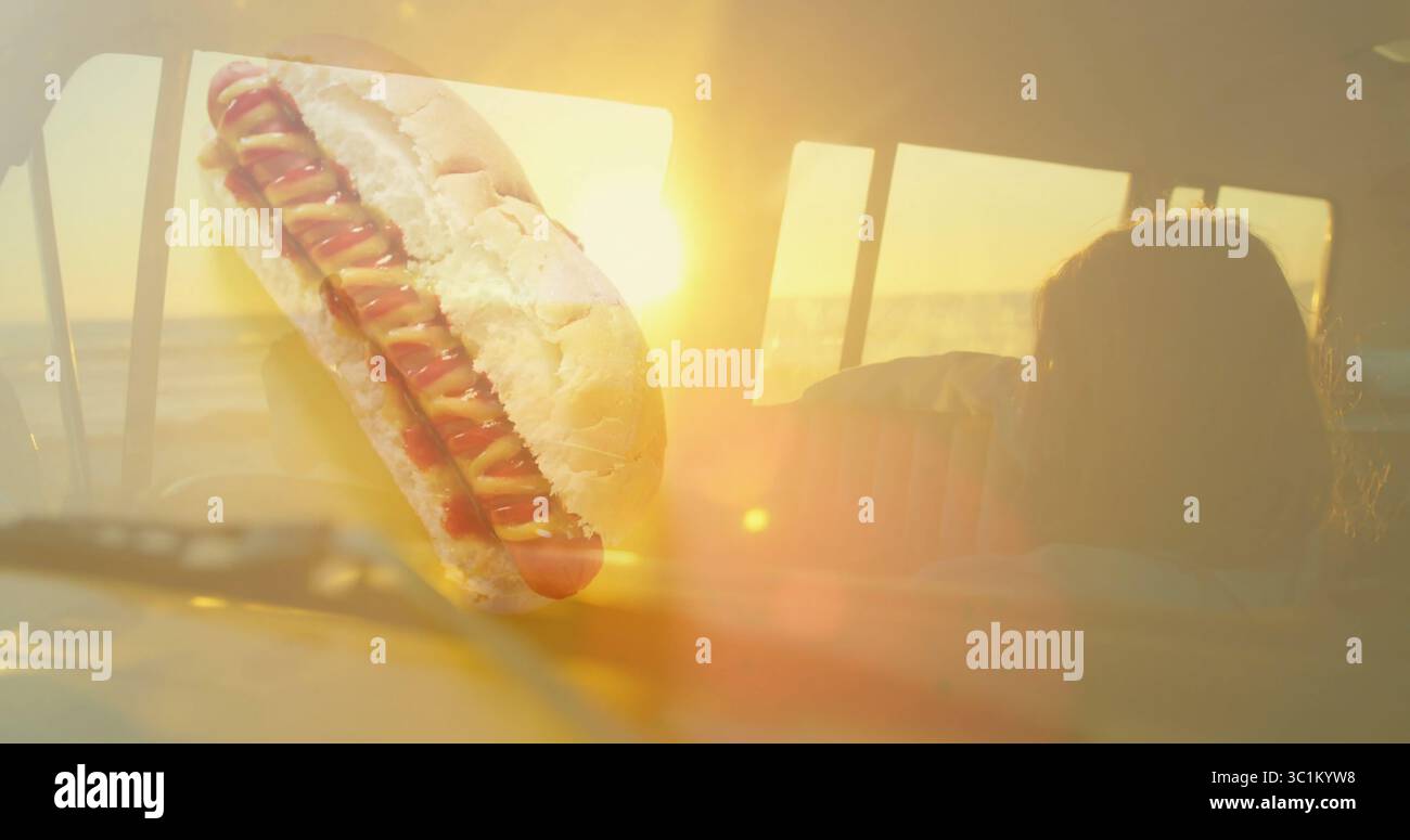 Floating hot dog dripping mustard and ketchup above car dashboard ...