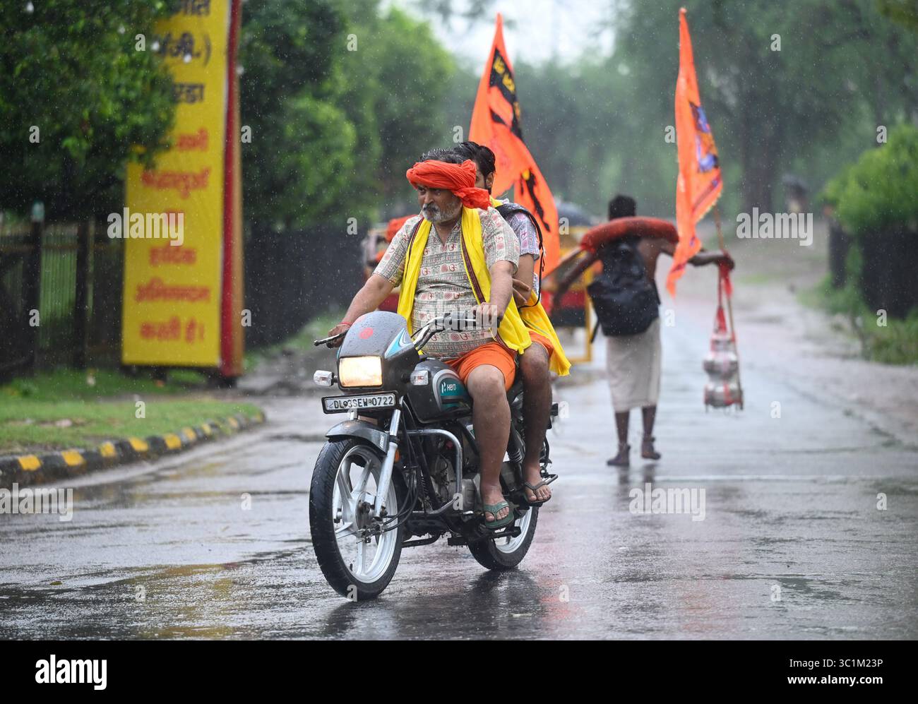NOIDA, INDIA - JULY 22: kavadiya seen during rain at Noida-Delhi border ...
