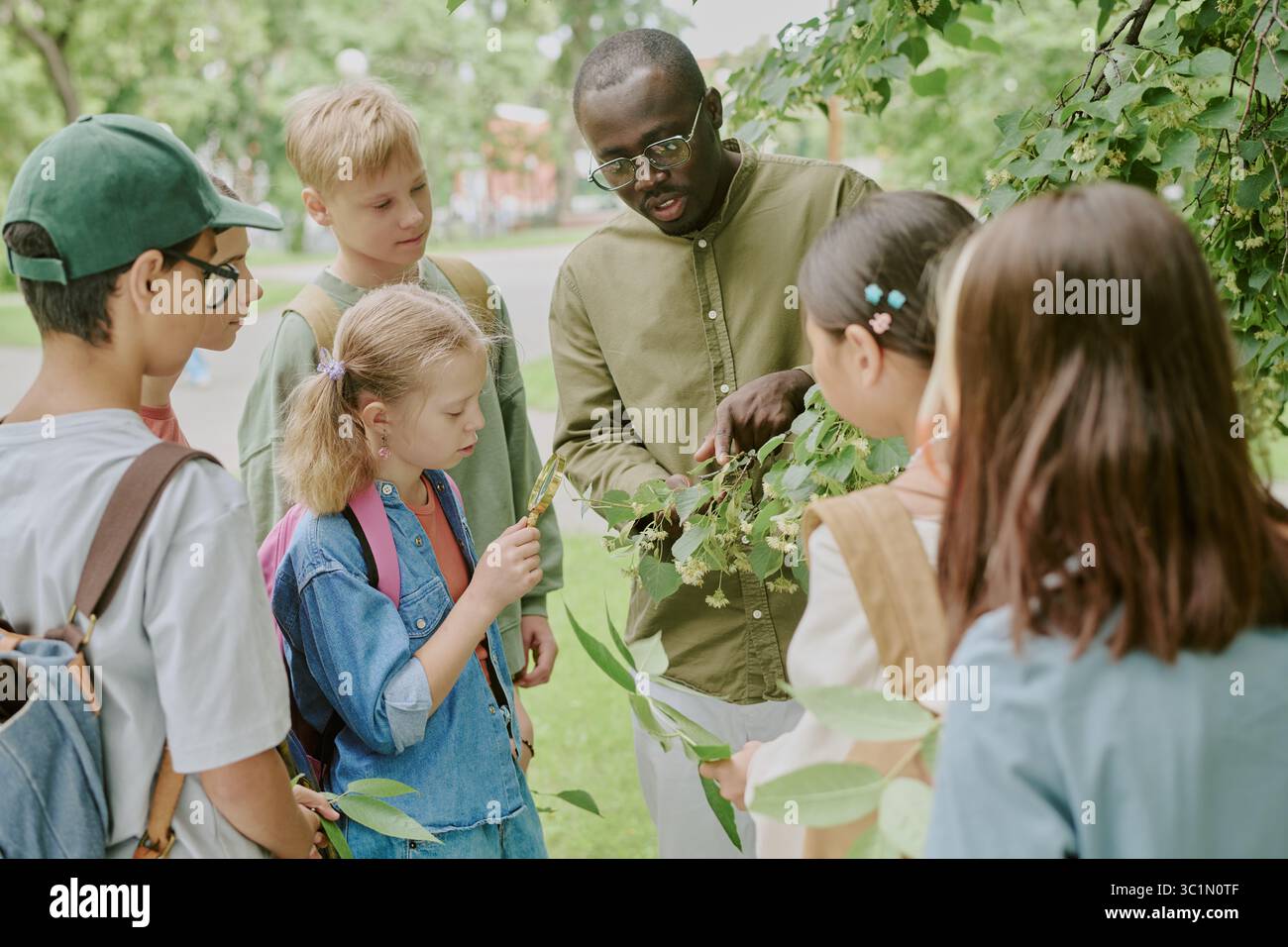 Multiethnic School Teacher Guiding Children Exploring Nature Outdoors ...