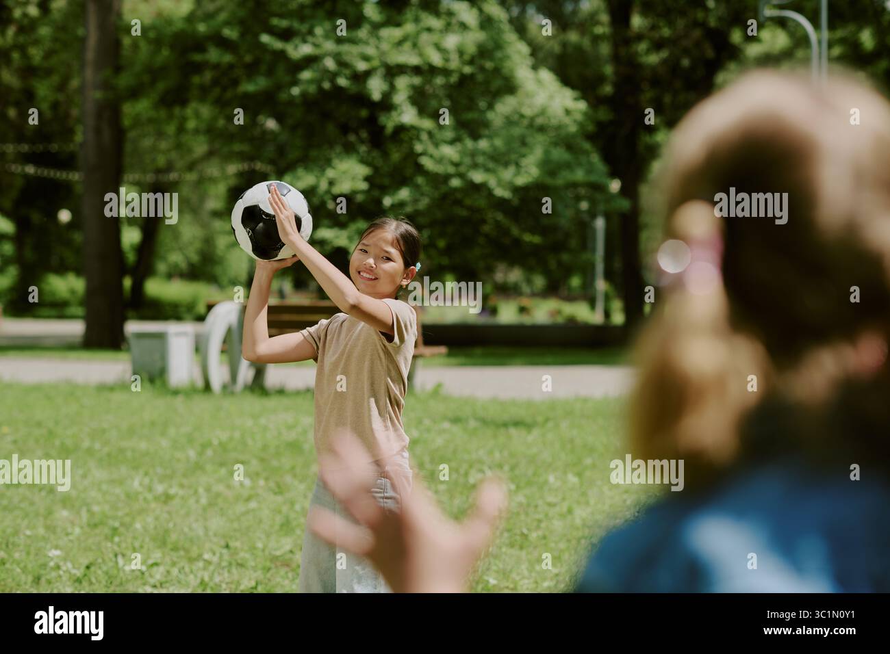Girl throwing soccer ball hi-res stock photography and images - Alamy