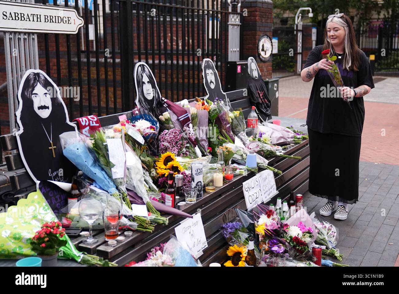 Floral tributes are left on the Black Sabbath Bridge bench on Broad ...