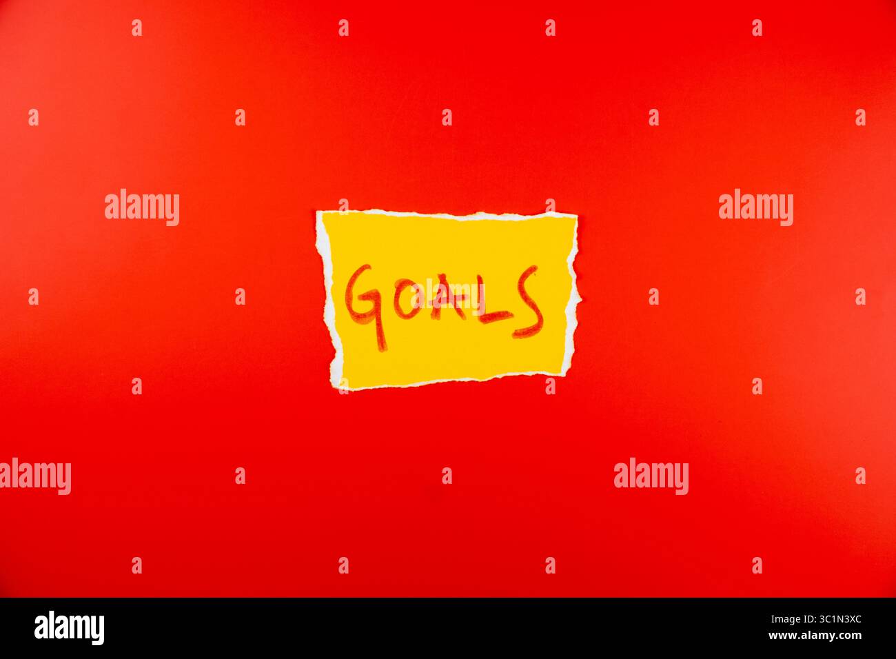 Yellow torn paper with the word goals on vibrant red background for ...
