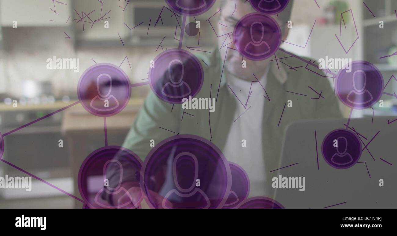 Typing man in green blazer at kitchen table, with laptop and floating ...