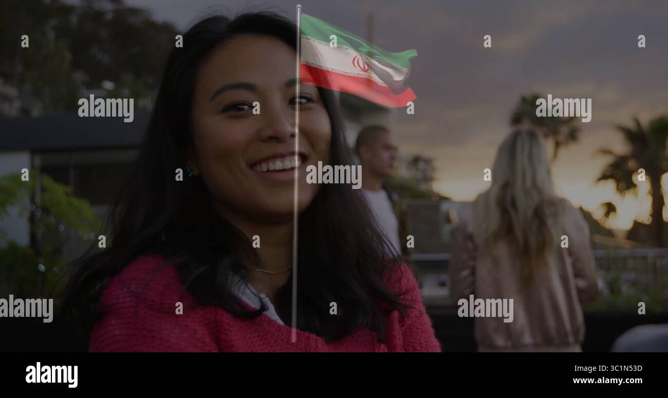 Smiling Asian woman wearing red sweater chatting on rooftop terrace ...