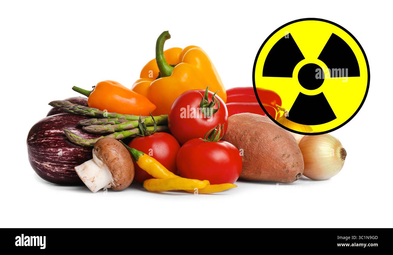 Fresh vegetables and radioactive sign on white background ...