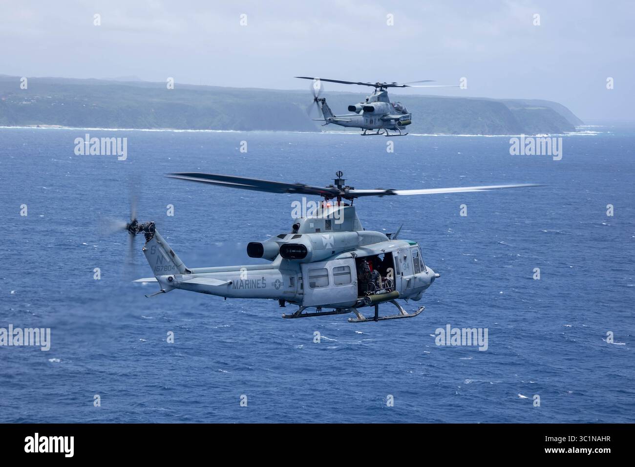 A U.S. Marine Corps UH-1Y Venom and an AH-1Z Viper helicopter with Marine Light Attack ...