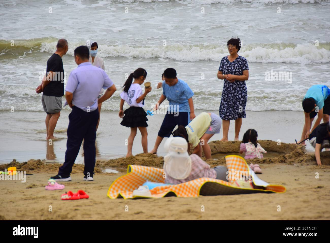 Tourists play at the seaside in Sanya City, southernmost China's Hainan ...