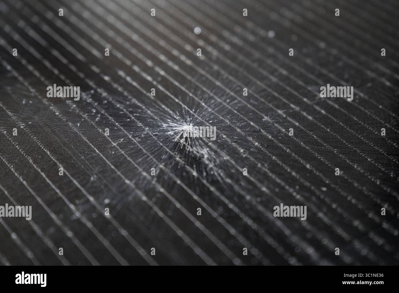 Close-up of a shattered photovoltaic solar panel displaying extensive ...