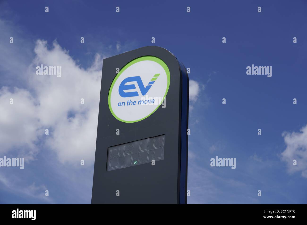EV electric charging point at EG On The Move petrol station Corporate logo signs in Wakefield ...