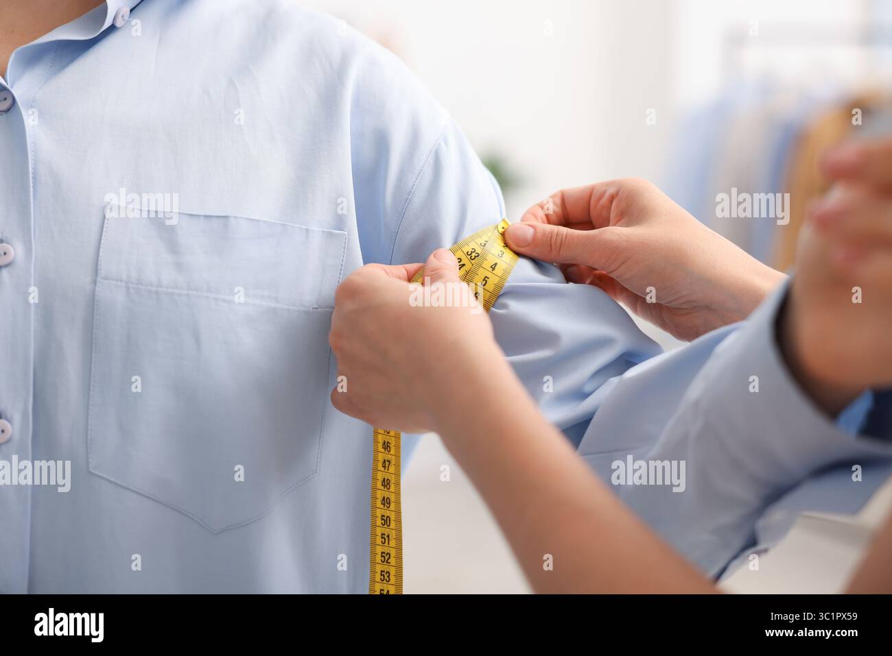 Tailor measuring womans arm hi-res stock photography and images - Alamy
