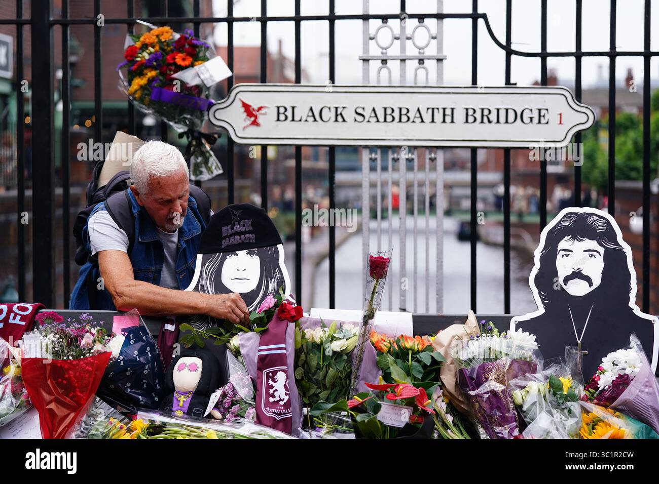 Floral tributes are left on the Black Sabbath Bridge bench on Broad ...