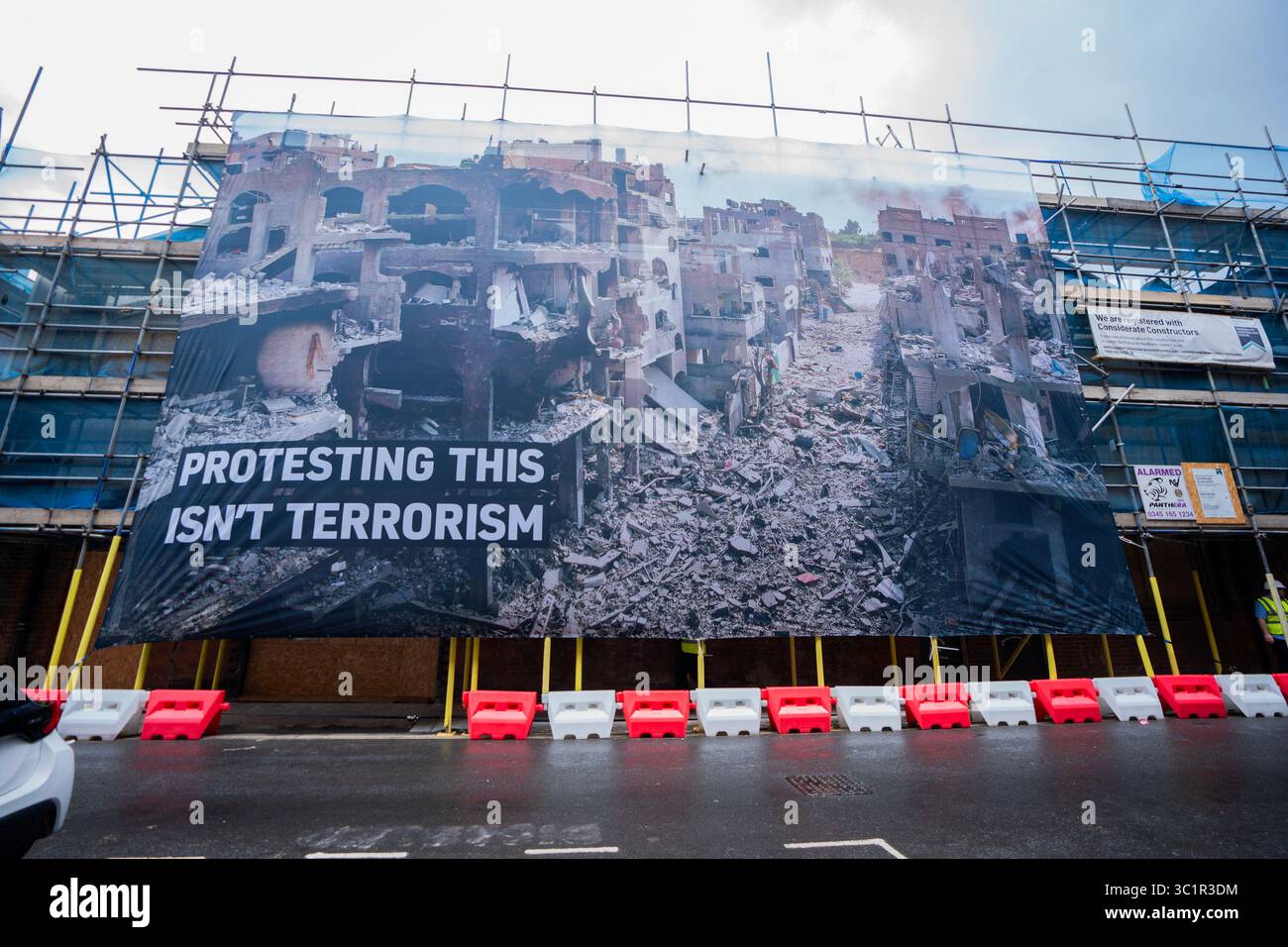 London, UK. 22nd July, 2025. Activists up a huge banner during the ...