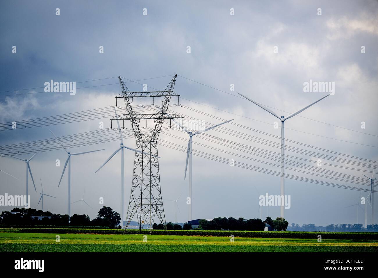 DRONTEN - Windmills along the road and high-voltage pylons in the ...