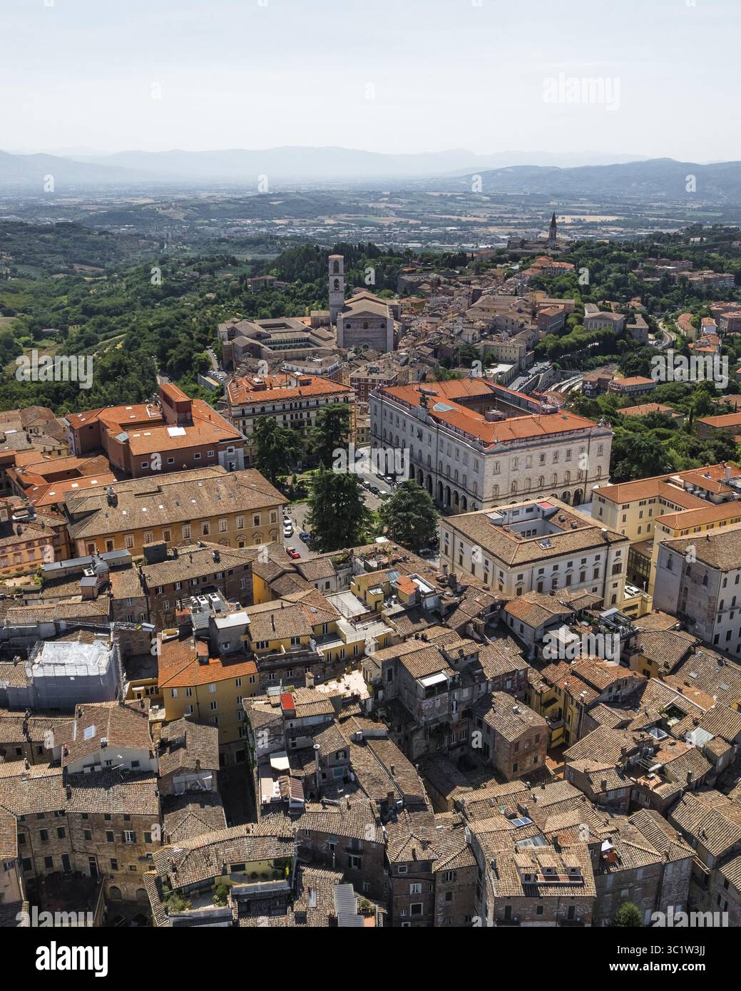 Aerial view of sun-kissed terracotta rooftops cascade down to ancient ...