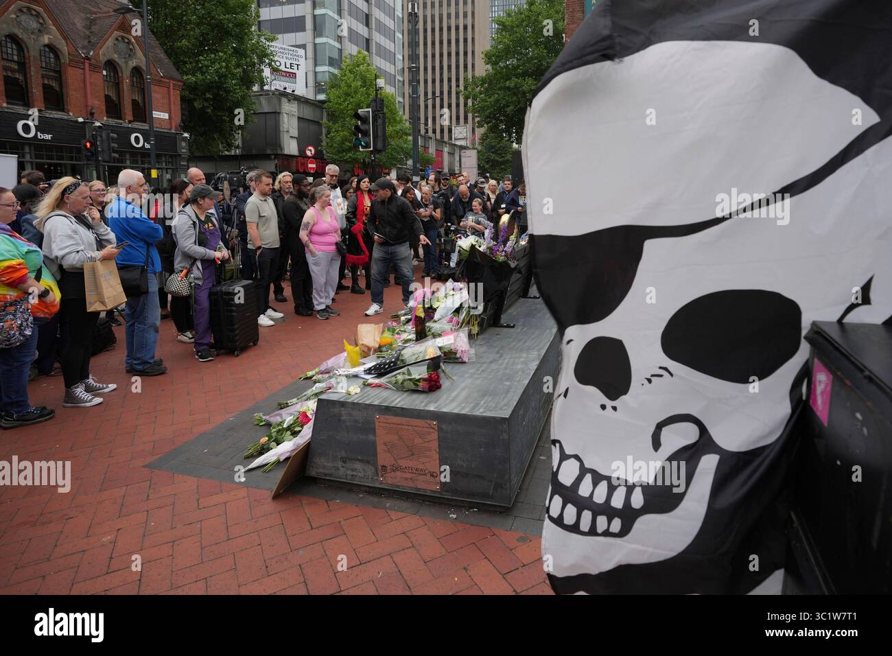 Flowers are left by fans to commemorate the death of Ozzy Osbourne at ...