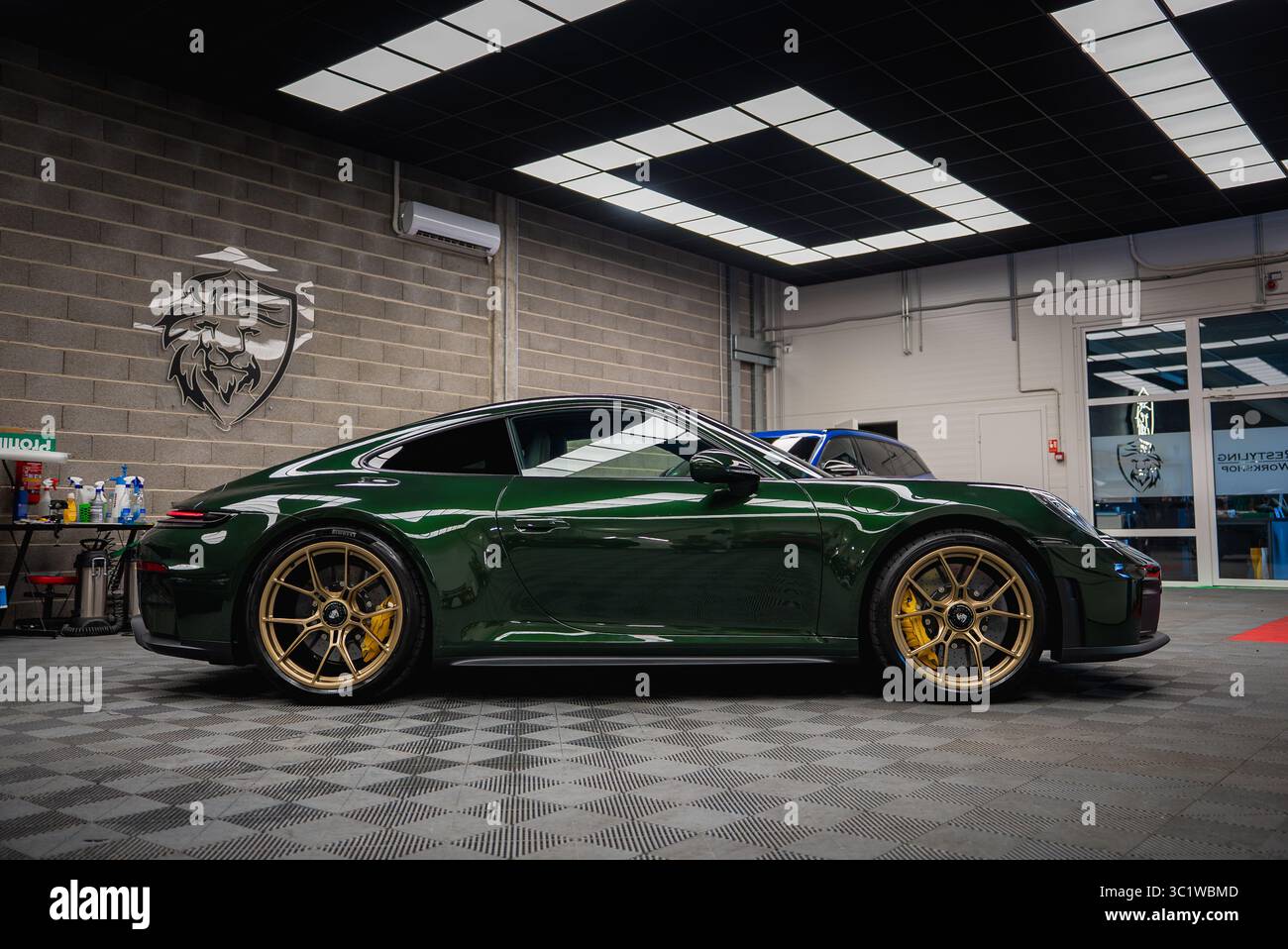 Green Porsche 911 GT3 Touring with Gold Wheels in Tuning Garage Stock ...