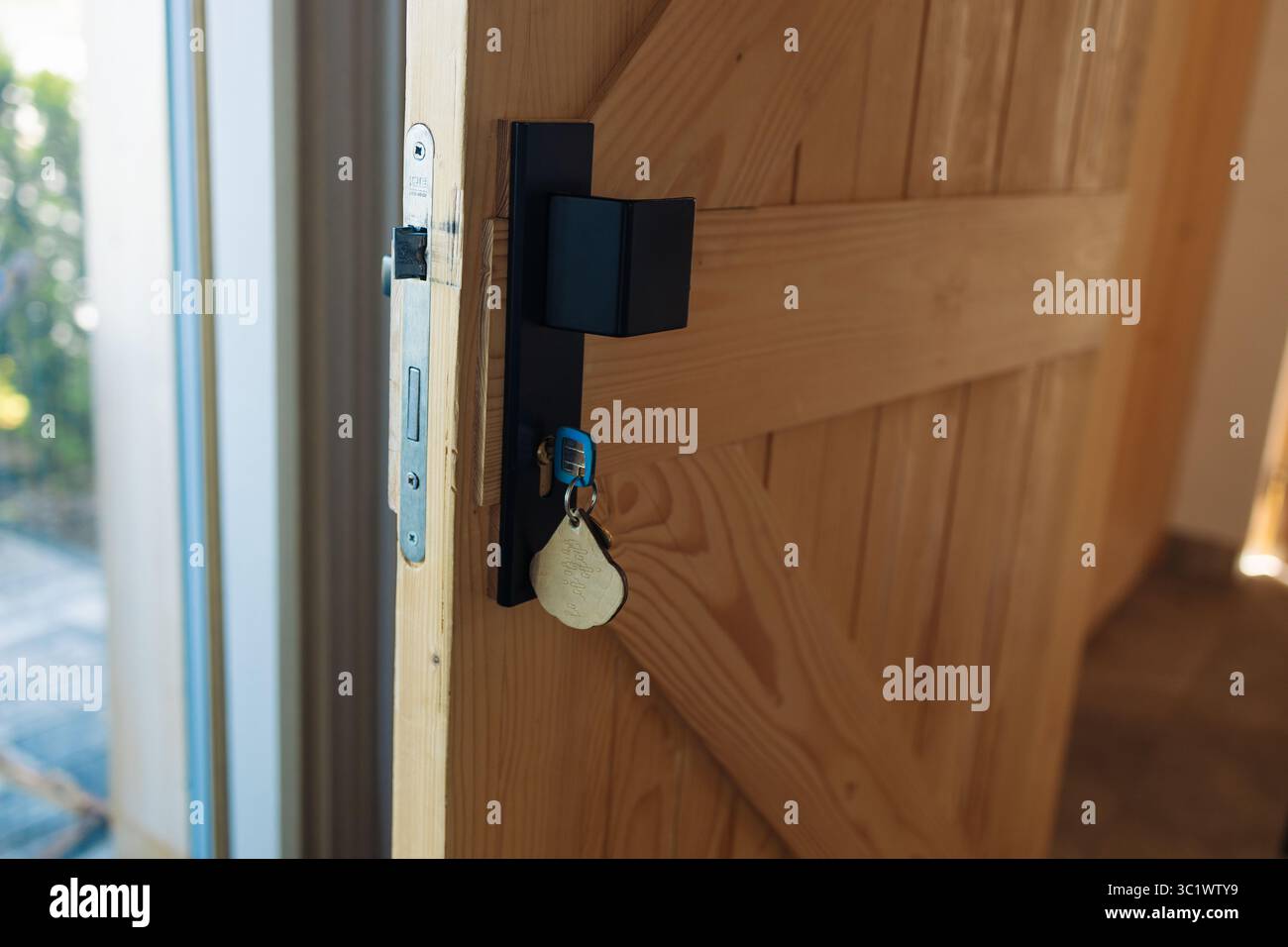Open Wooden Door with Key in Modern Lock Stock Photo - Alamy