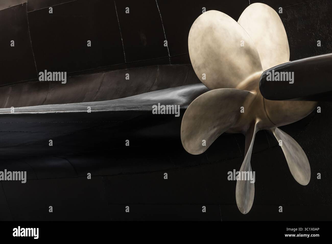 Submarine boat propeller with six blades attached to a sleek black hull ...