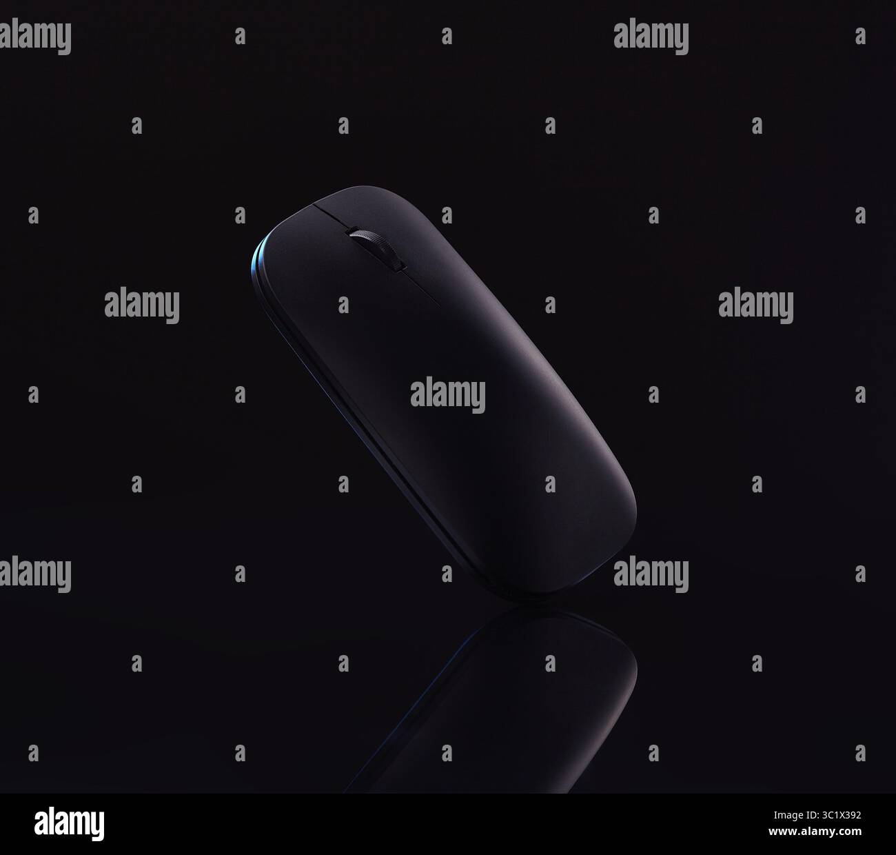 A sleek, black mouse rests on a dark surface, with a mirror reflecting ...