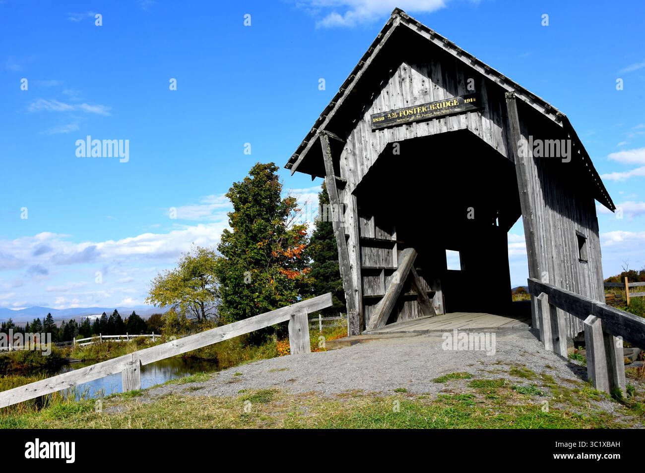 Weathered and faded, A. M. Foster Covered Bridge is constructed of wood ...