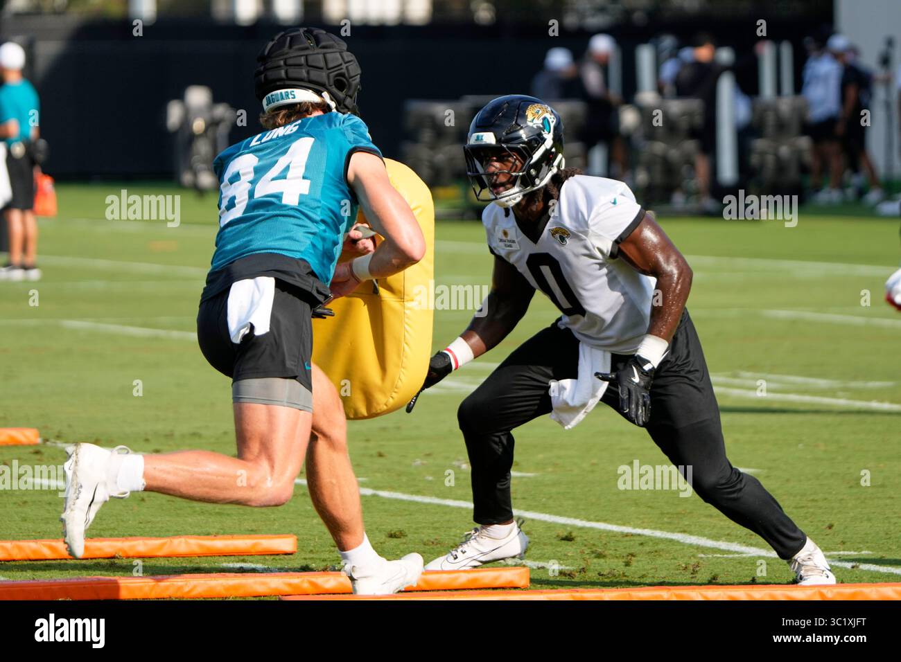 Jacksonville Jaguars linebacker Devin Lloyd, right, and tight end ...
