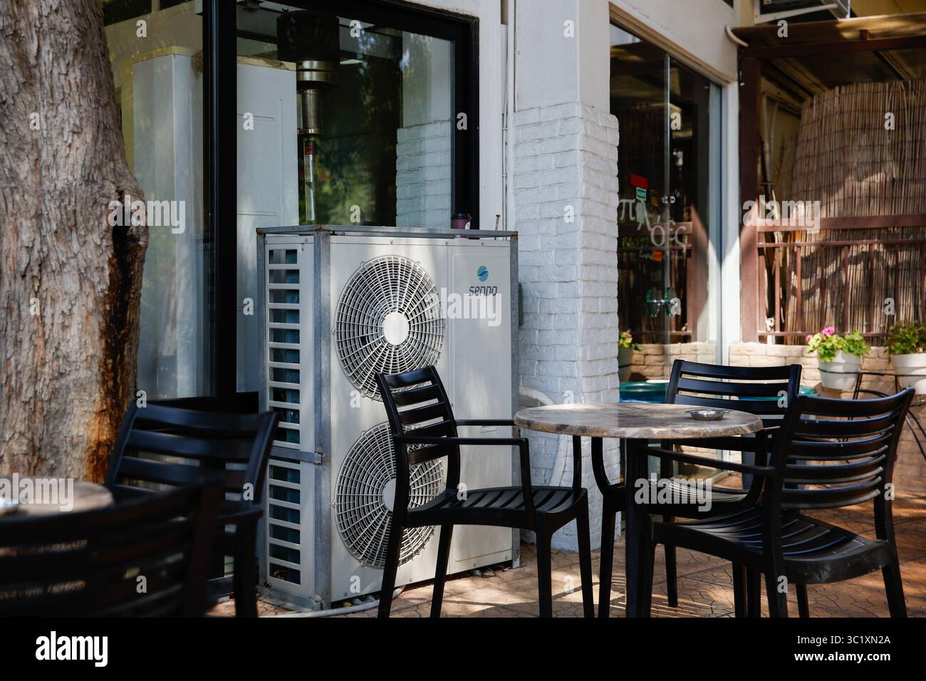 23 July 2025, Greece, Athen: An outdoor air conditioning unit stands on ...