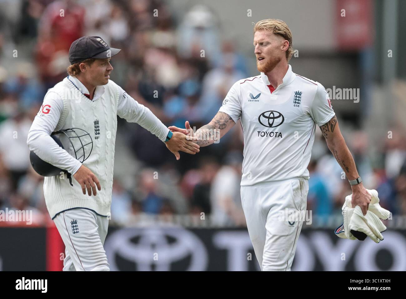 Ollie Pope gives England captain Ben Stokes a high five as they head in ...