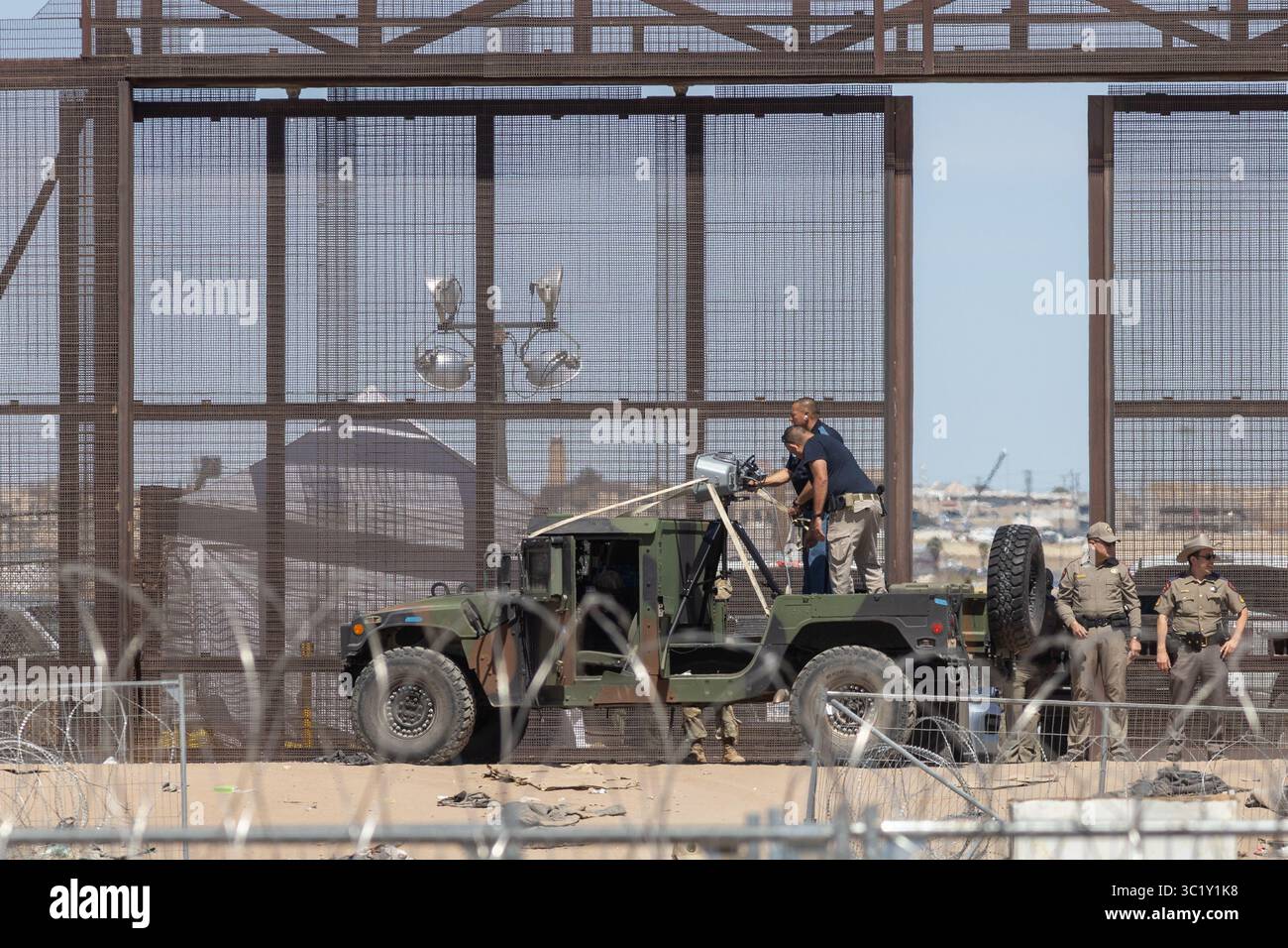Military personnel inspect equipment by a border fence near Ciudad Juarez, a hotspot for ...