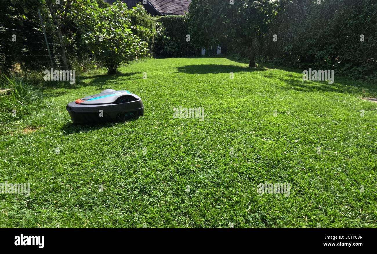 Autonomous lawn mower efficiently cutting hi-res stock photography and ...