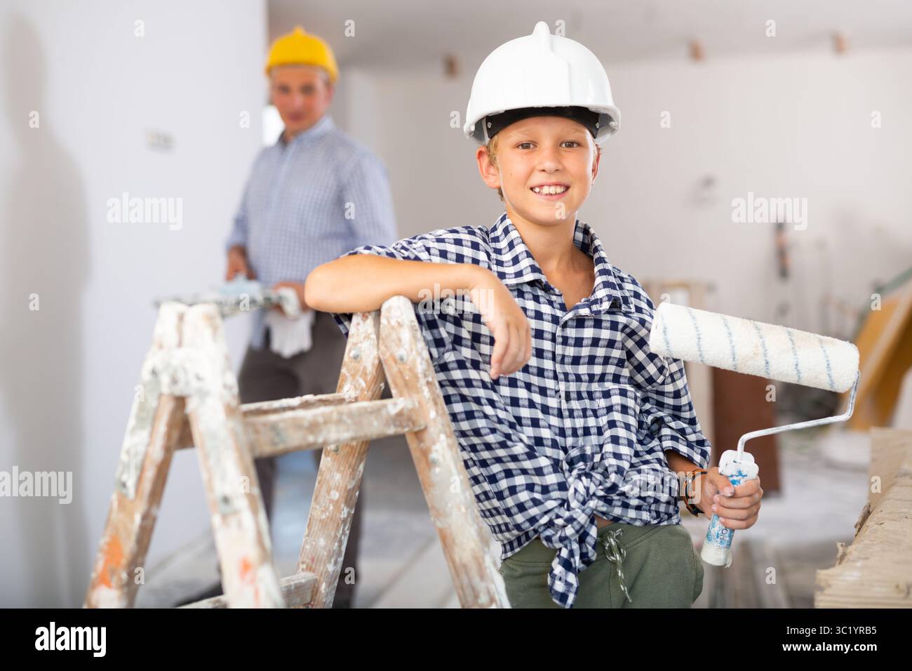 Boy posing with tools for home renovation Stock Photo - Alamy