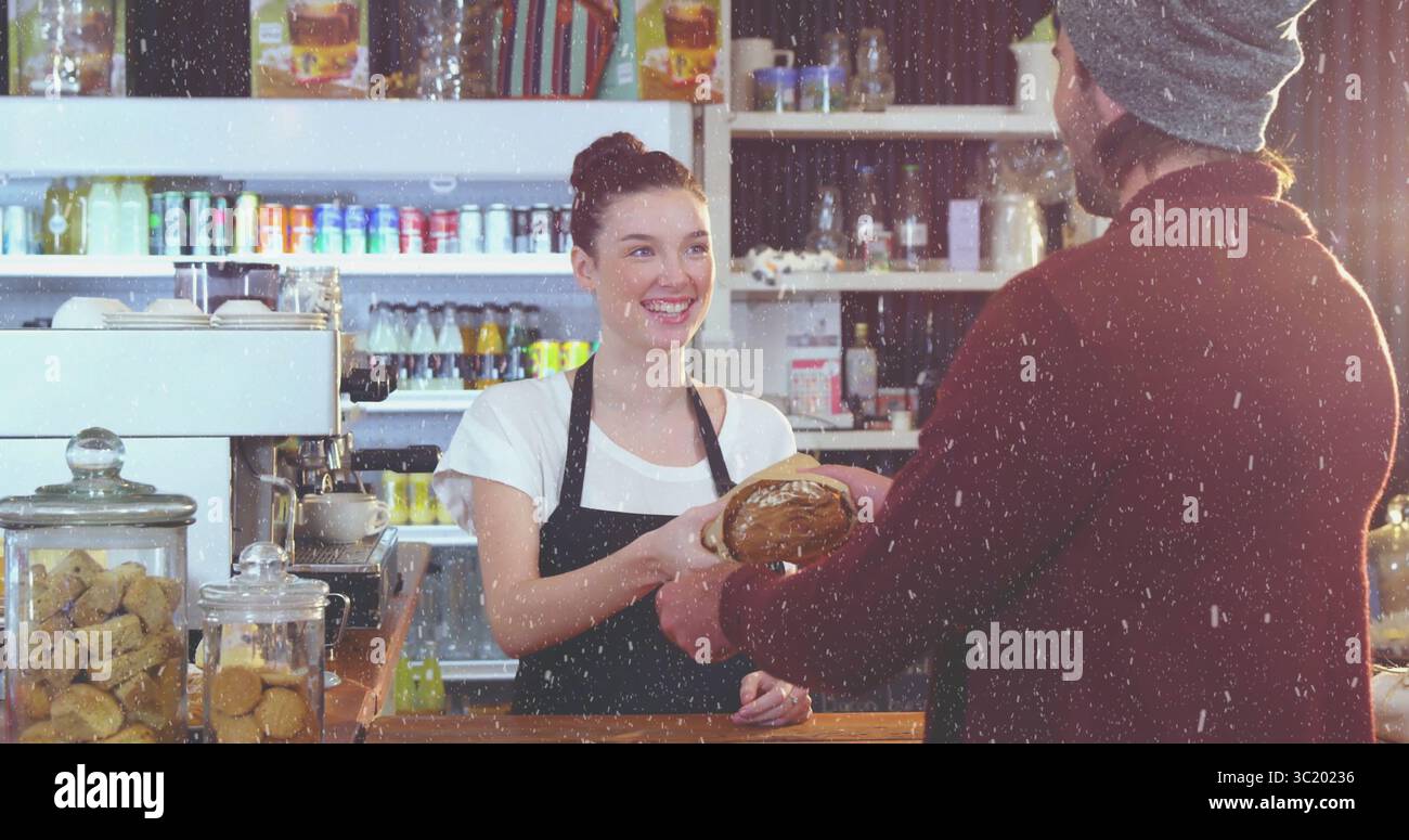 Barista wearing black apron handing loaf of bread at coffee shop ...