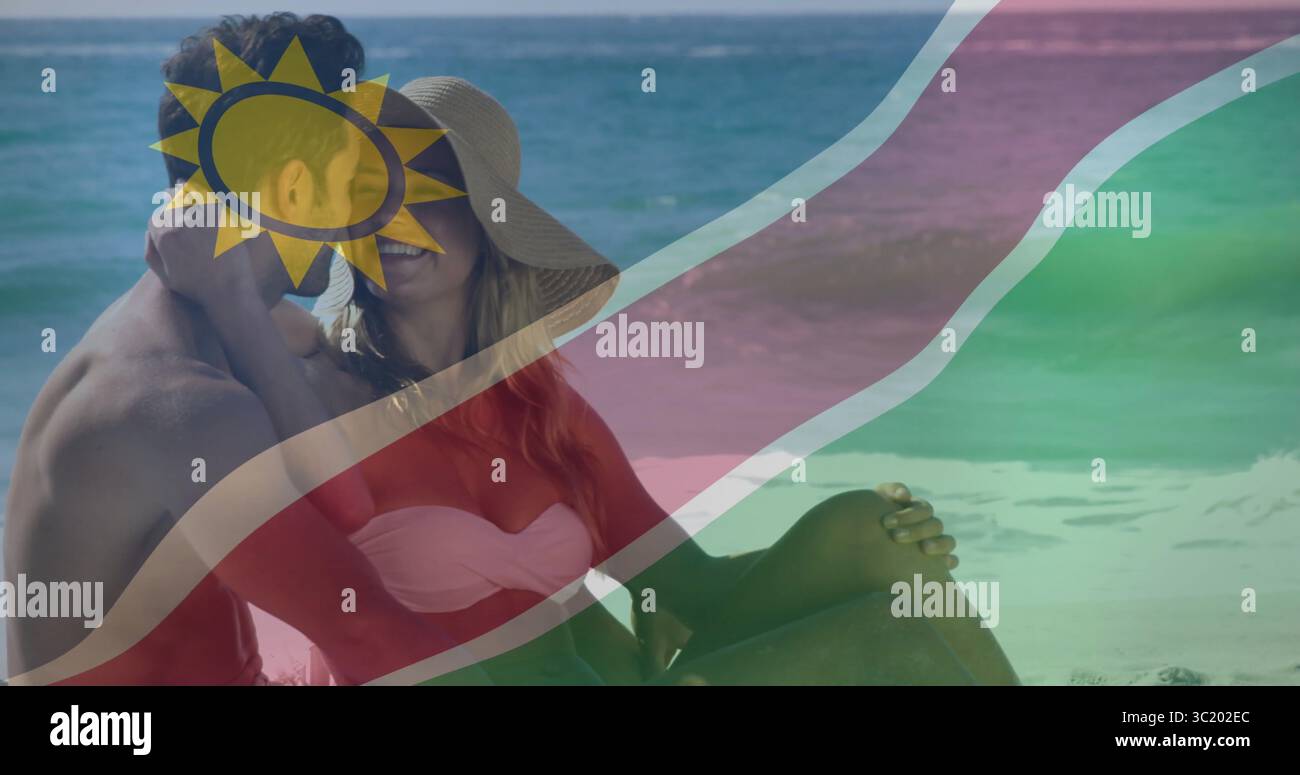 Sitting romantic couple wearing swim trunks and bikini on sandy beach ...