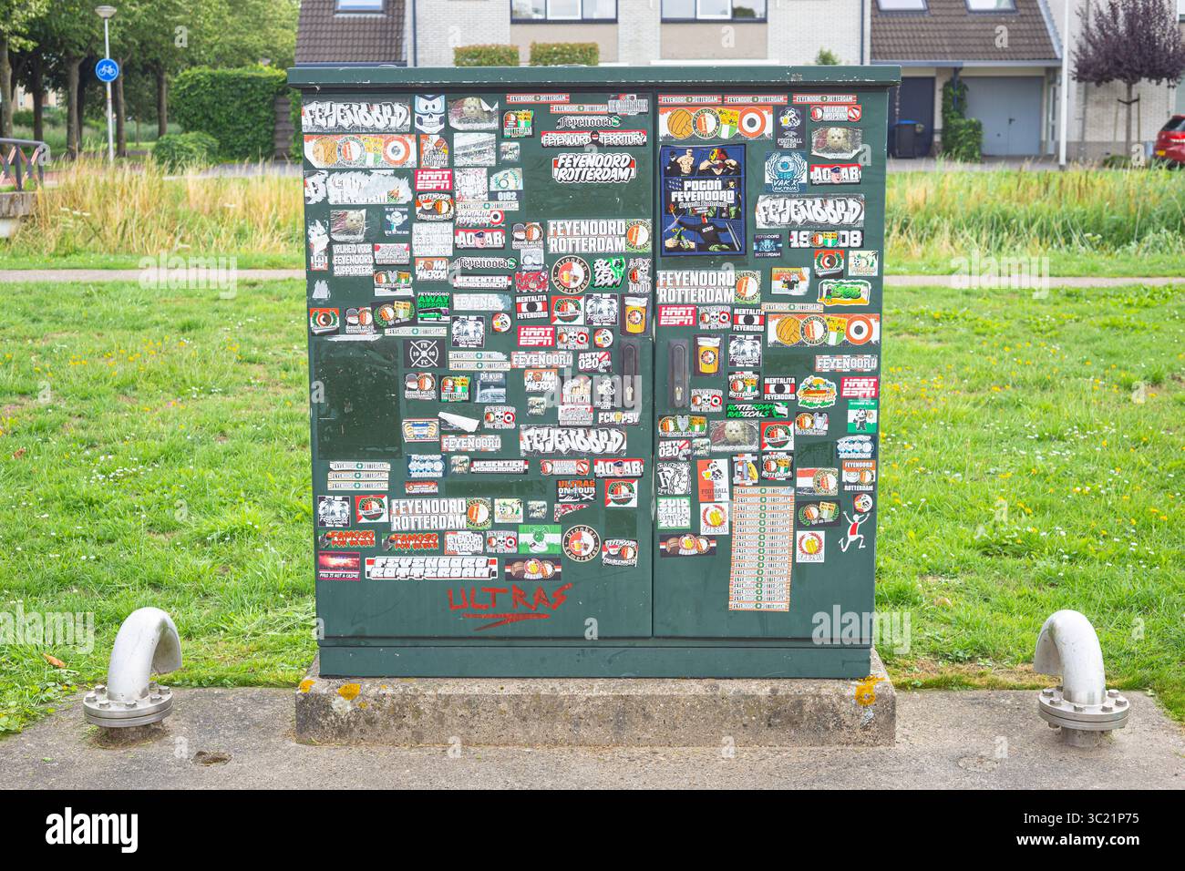 Electricity Box Decorated With Various Stickers in a Public Green Area ...
