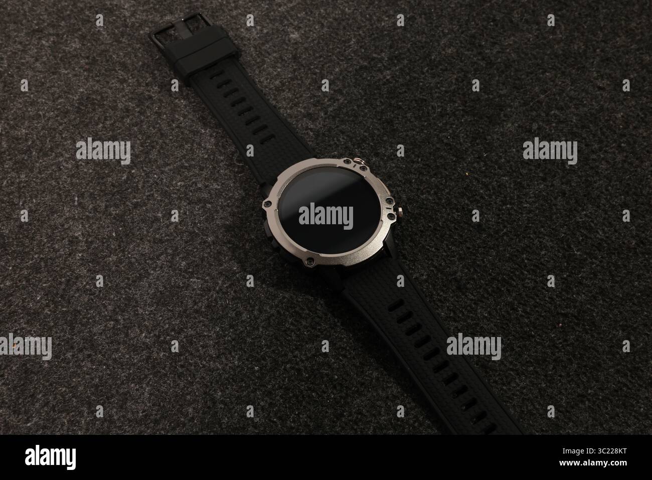 Modern Smartwatch with Black Strap and Silver Bezel on Black Surface ...