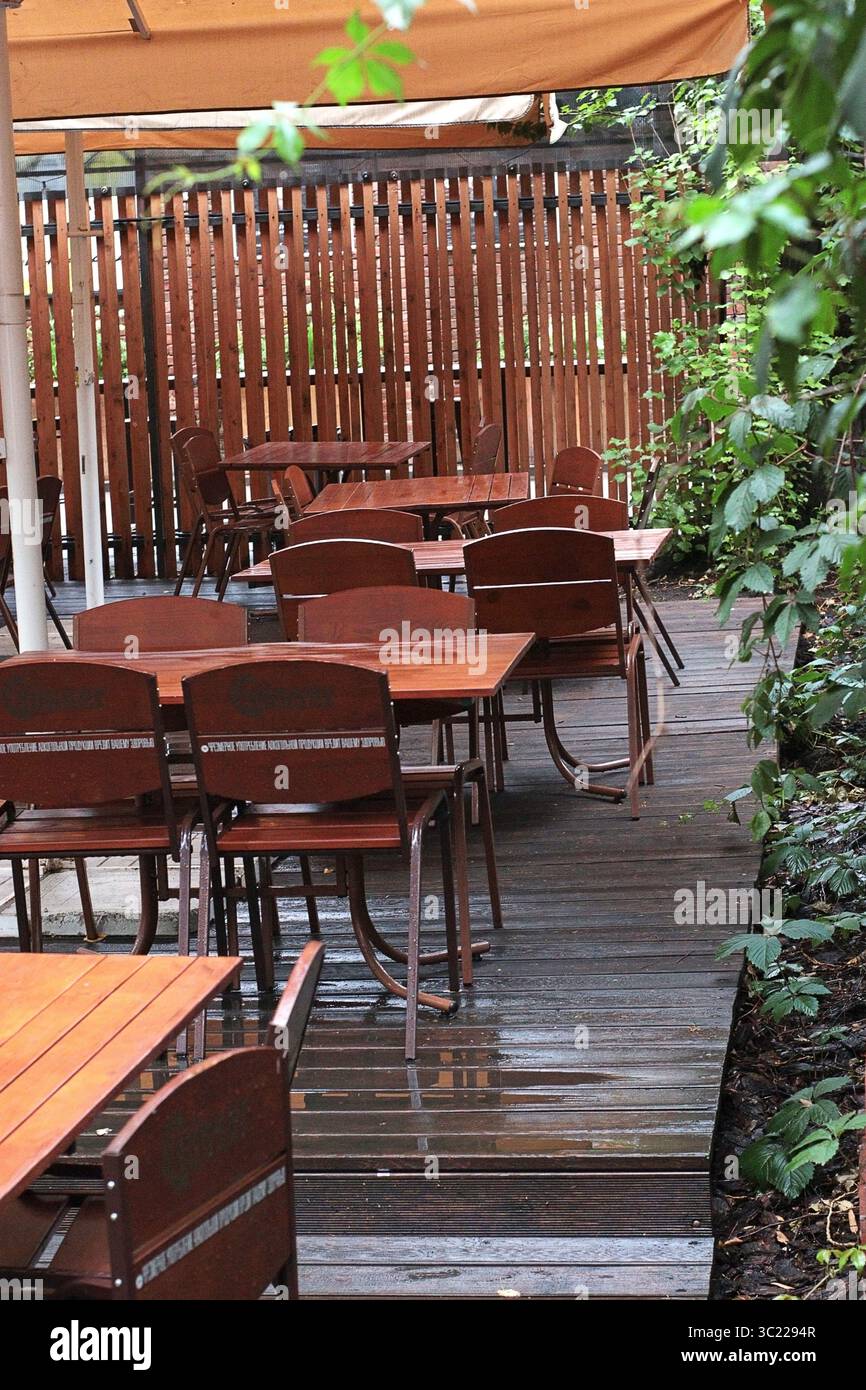 Wooden outdoor furniture in restaurant, cafe - tables and chairs on ...