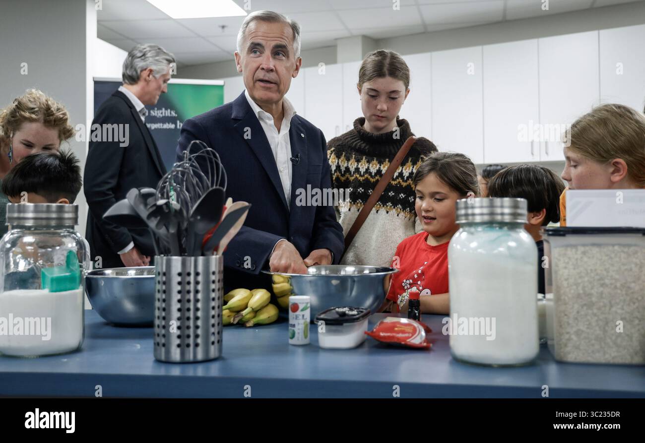 Prime Minister Mark Carney, centre, makes banana muffins with summer ...