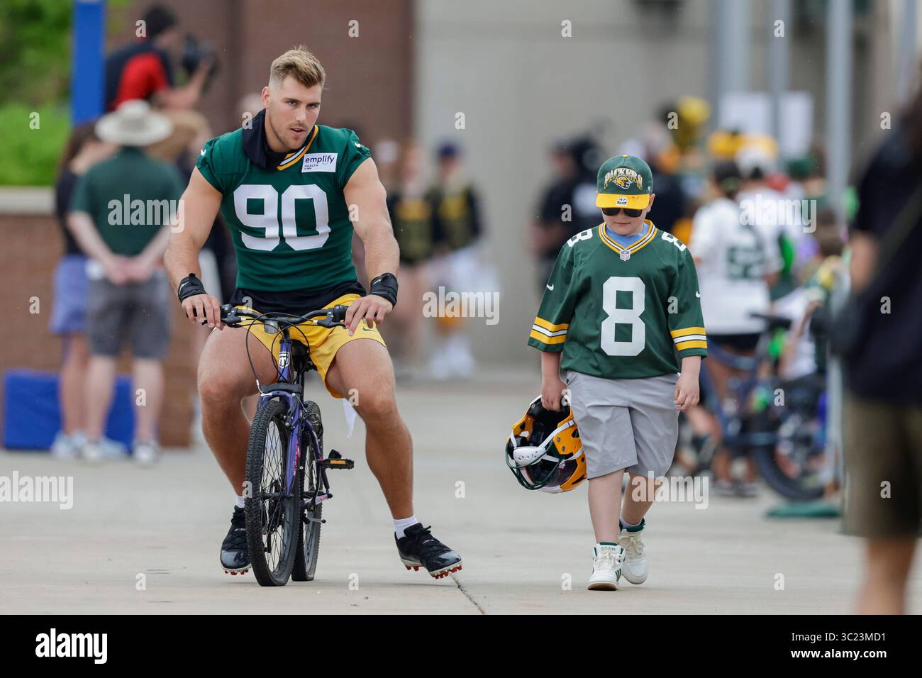 Green Bay Packers' defensive lineman Lukas Van Ness rides a bike to an ...