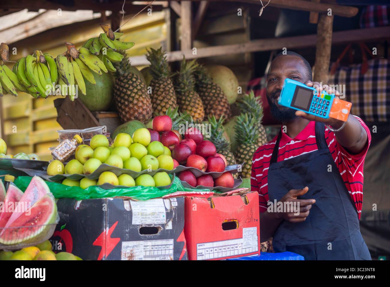 african market man selling fruits items counting money Stock Photo - Alamy